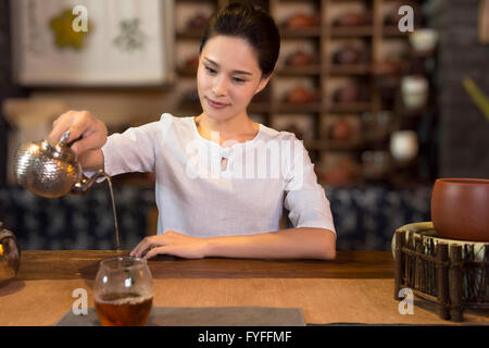 Tea house owner making tea Stock Photo - Alamy