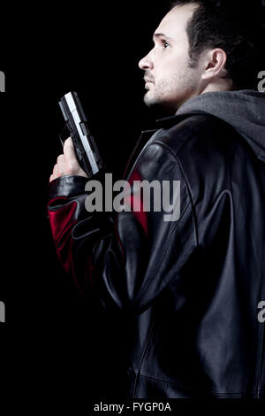 Lone man armed with a pistol, robber Stock Photo - Alamy