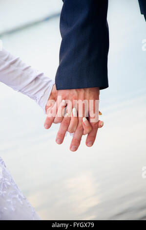 wedding couple hand in hand Stock Photo - Alamy