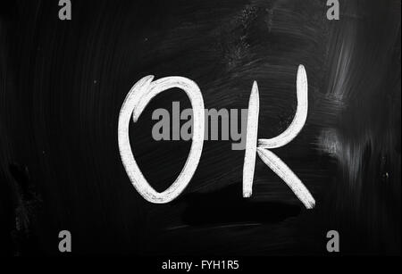 OK handwritten with white chalk on a blackboard Stock Photo - Alamy