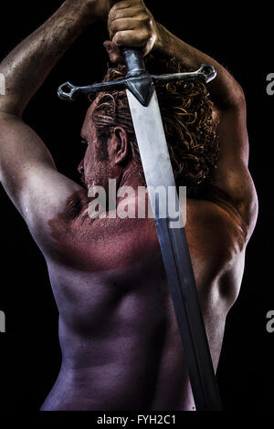 Warrior with big sword, muscular back Stock Photo - Alamy