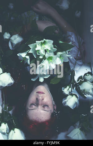 Young drown woman in a poetic representation. The concept of the undead ...