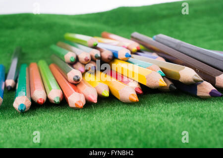 Color pencils scattered on green grass Stock Photo - Alamy