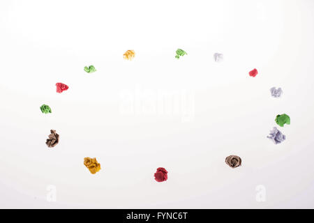 Colorful crumpled papers form a round shape on white background Stock ...