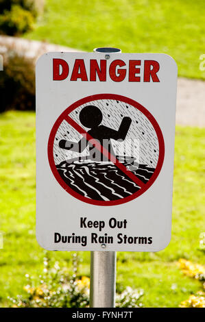 Danger, Keep out during rain storms sign Stock Photo - Alamy