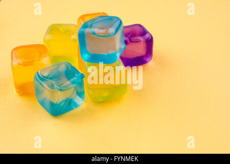 Colorful little cubes on a yellow background Stock Photo - Alamy