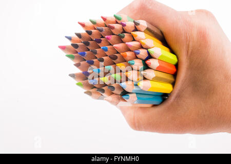 Hand holding color pencils on a white background Stock Photo - Alamy
