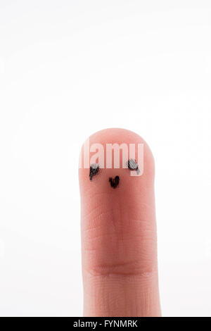 Black dots forming a face on the fingertip Stock Photo - Alamy