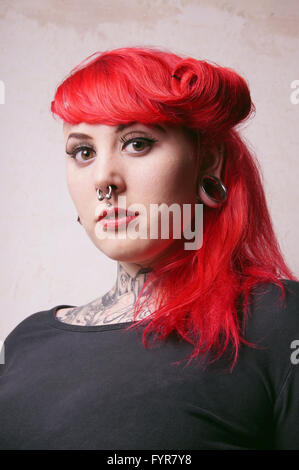 Portrait of a confident young woman with a septum piercing, showcasing ...