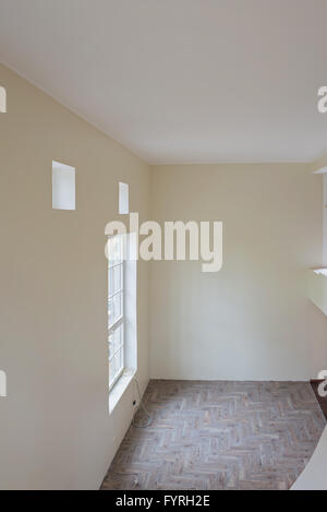 an unfinished room with wood flooring and walls being stripped down to ...