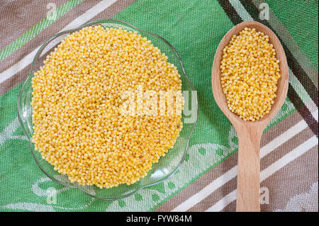 glass of raw millet grains Stock Photo - Alamy