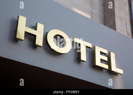 Gold Hotel Sign on Grey Background Stock Photo - Alamy