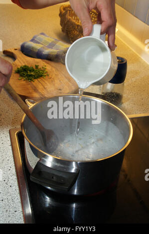 Cooking shaggy ink cap soup Stock Photo - Alamy