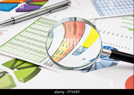 Close up of chart paper and magnifying glass Stock Photo - Alamy