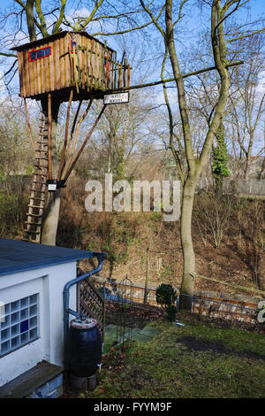 A vertical shot of wooden huts in terraced rice fields and mountains in ...