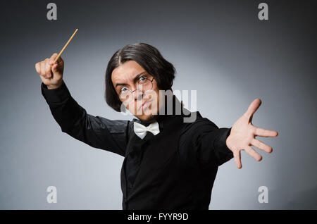 Funny conductor in musical concept Stock Photo - Alamy