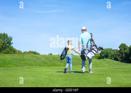 Family on a golf course Stock Photo - Alamy