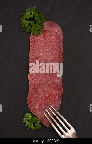 Salami in discs cut Stock Photo - Alamy