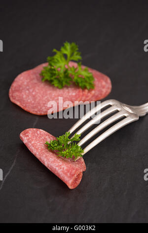 Salami in discs cut Stock Photo - Alamy