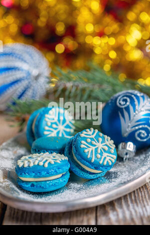 Christmas decor with tasty macarons on color background Stock Photo - Alamy
