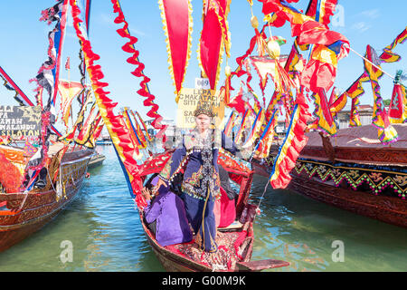 Bajau lady dancing on traditional boat called Lepa Lepa decorated with ...