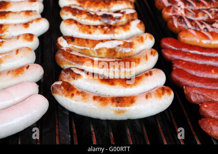 Grilled Bockwurst and Bratwurst meat sausages on a cleaver. Isolated on ...