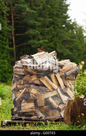 firewood in net bag Stock Photo - Alamy