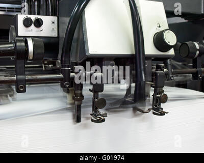 Sheet offset machine draws paper in printery Stock Photo - Alamy