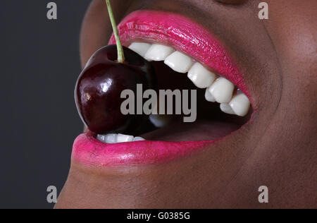 Cherry in teeth, macro, close up. Cherry in woman mouth. Cherries on ...