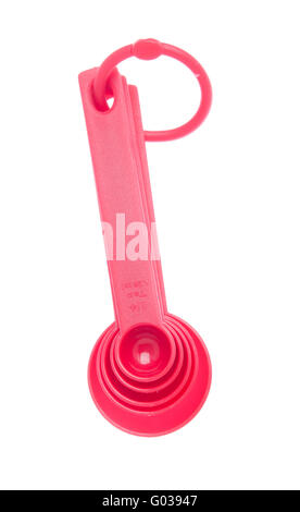 Red plastic measuring spoons for cooking. White background. View from ...