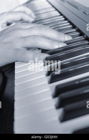 Hands above keys of the piano. Monochrome tone Stock Photo - Alamy