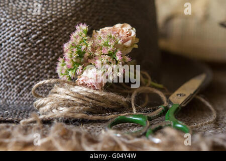 Still life of scissors,small bouqet with flowers and cord Stock Photo ...