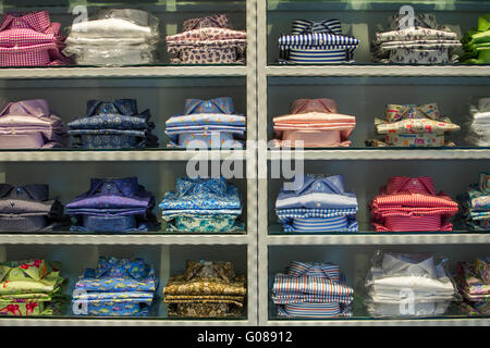 Neat stacks of folded clothing on the shop shelves. Color folding shirt ...