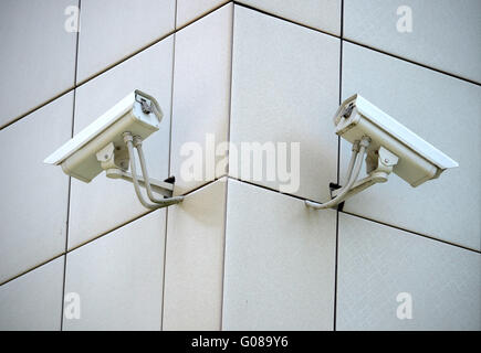 Two CCTV cameras on the cone of the morden building Stock Photo - Alamy