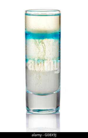 Shot sliced alcohol cocktail with blue drops isolated on white ...