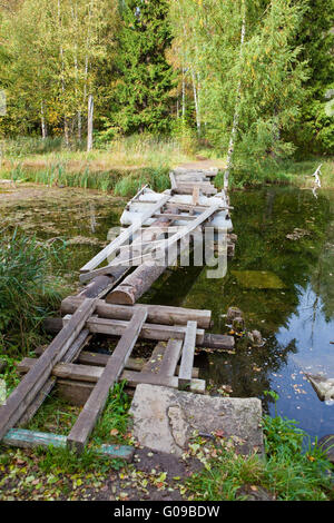 The small shabby bridge in park over a pond Stock Photo - Alamy