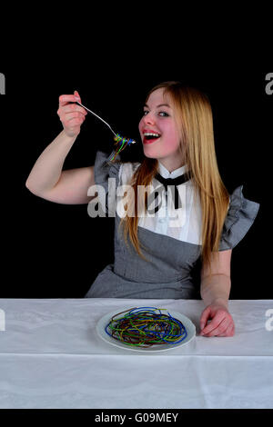Young woman eating the cable Stock Photo - Alamy