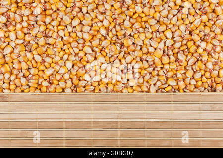Corn grain and bamboo mat, with place for your text Stock Photo - Alamy