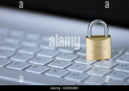 Small padlock sitting on white computer keyboard, online security ...