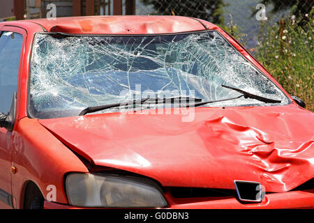 Broken windscreen at red car in traffic accident Stock Photo - Alamy