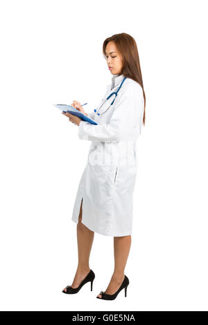 Asian female doctor writing medical notes in bright modern clinic ...