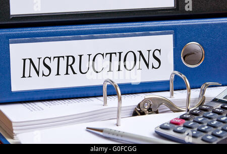 Instructions - blue binder in the office Stock Photo - Alamy