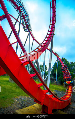 crazy rollercoaster rides at amusement park Stock Photo - Alamy