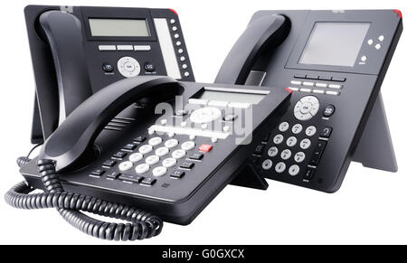 Three office digital telephone sets with LCD isolated on the white ...