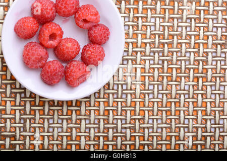 Big Pile of Fresh Raspberries and leaf in transparent bowl isolated on ...