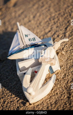 sailing boat and seashell in sand decoration closeup holiday background ...