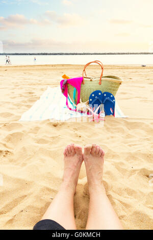 sunbathing accessories on sandy beach Stock Photo - Alamy