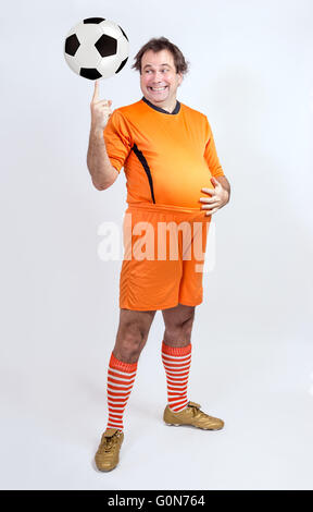 fat football player juggles with a ball on one finger Stock Photo - Alamy