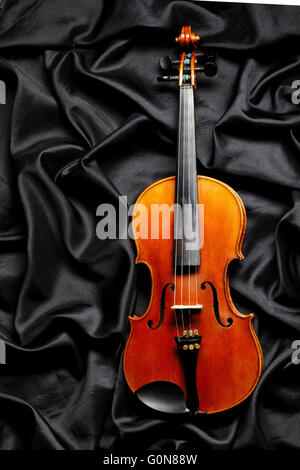 Classical violin on fabric background Stock Photo - Alamy