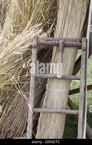 Thatcher's tools - with straw thatching Stock Photo - Alamy